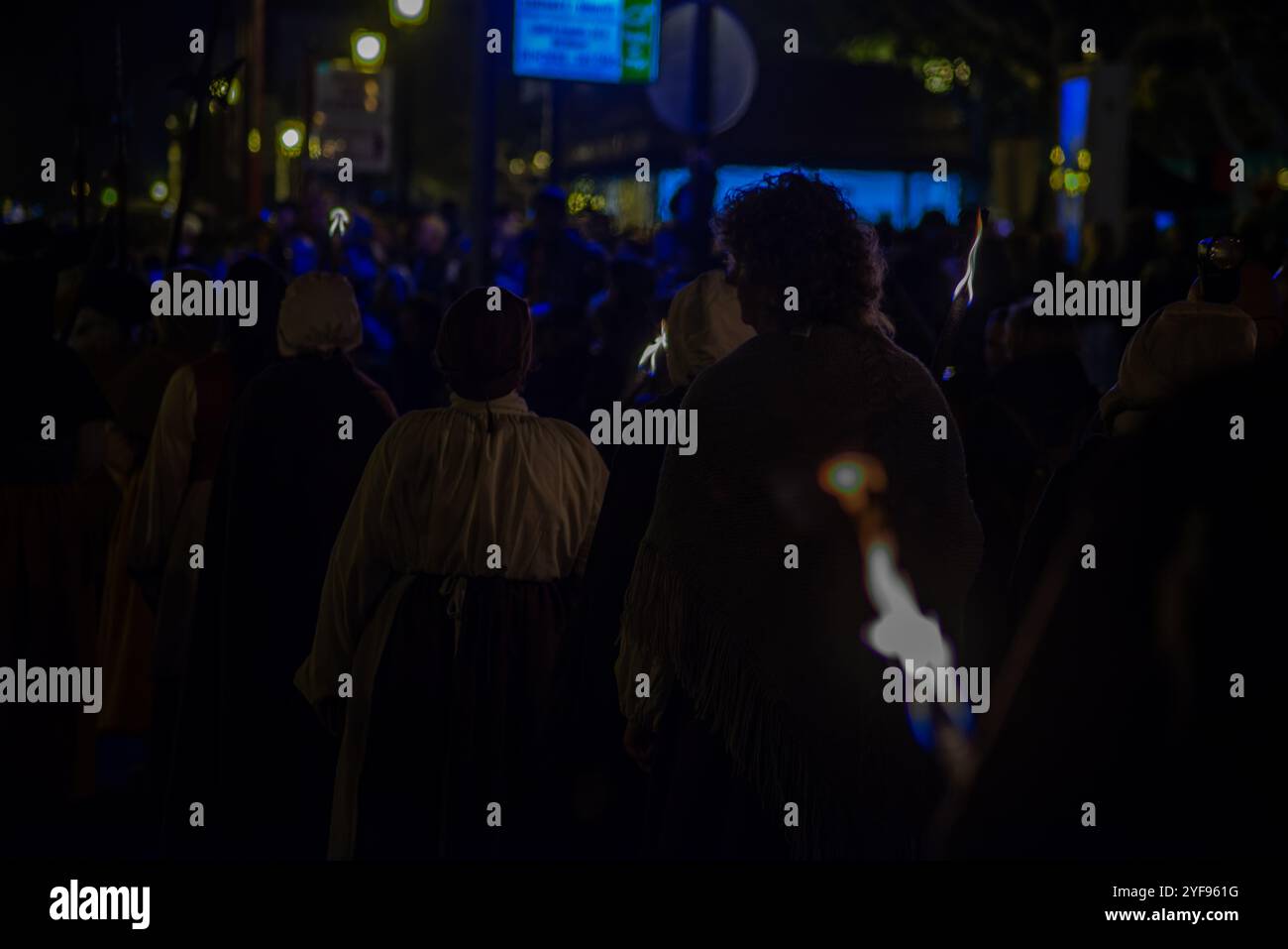 Actor characterized with pale makeup and costumes with flames in night ...