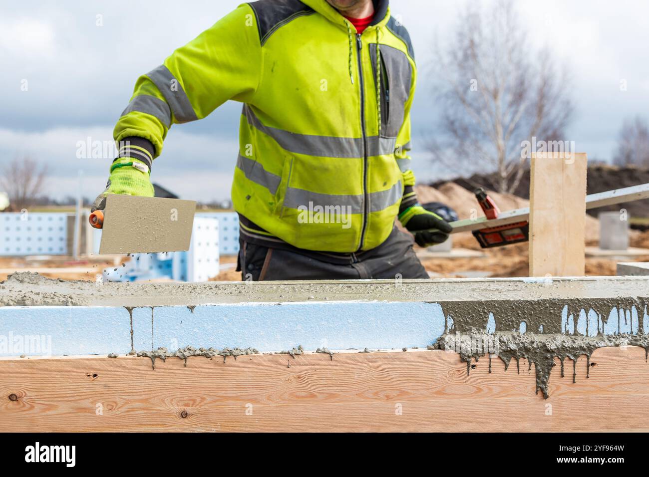 Focused Construction Worker Applying Smooth Finish to Fresh Concrete on ...