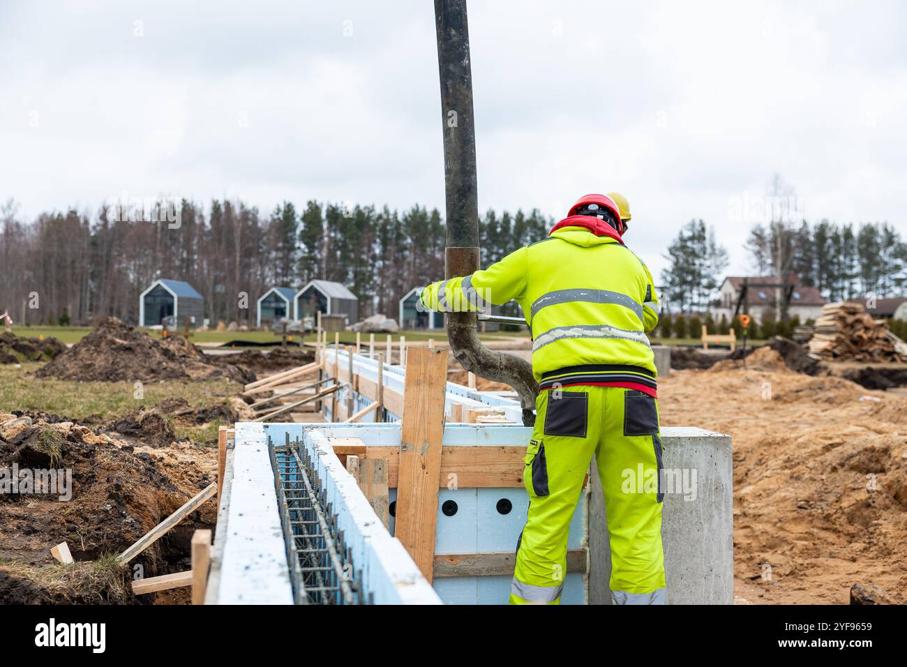 Construction Worker Precisely Operating Concrete Pump at New Building ...