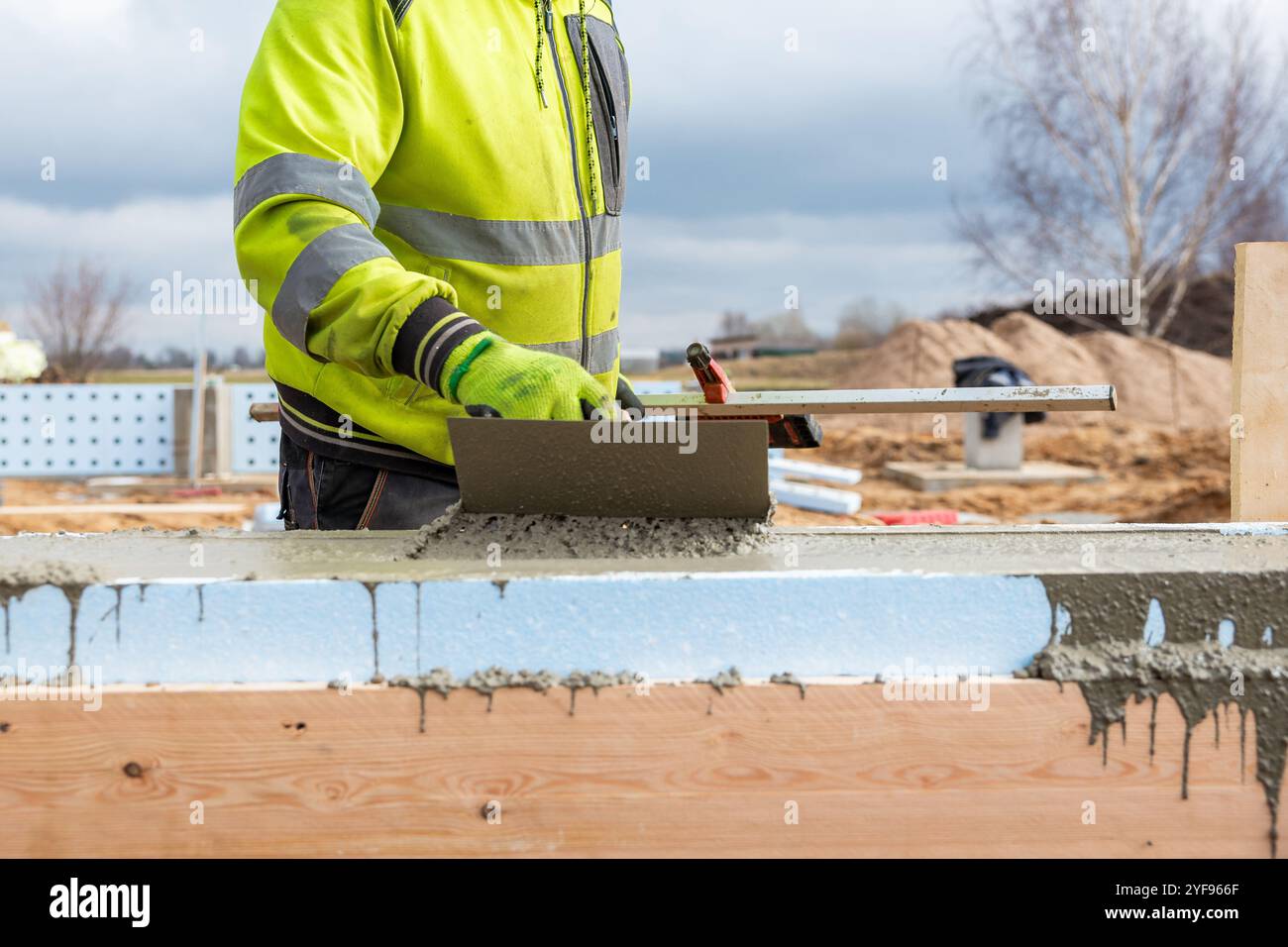 Focused Construction Worker Applying Smooth Finish to Fresh Concrete on ...