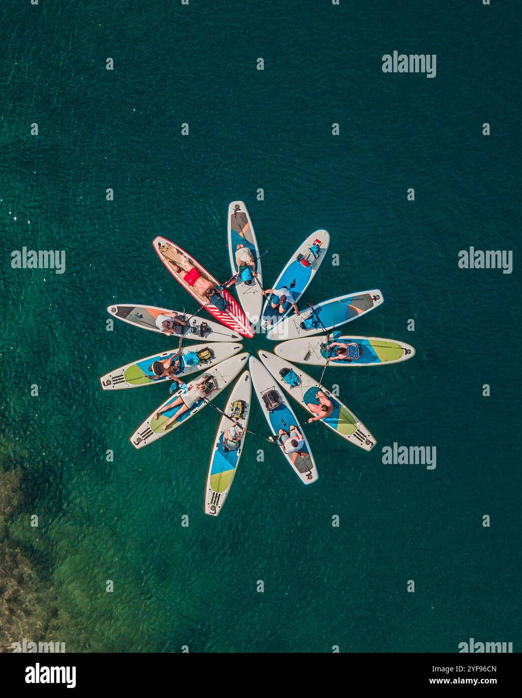 aerial view of a group of paddleboarders forming a star pattern on the ...