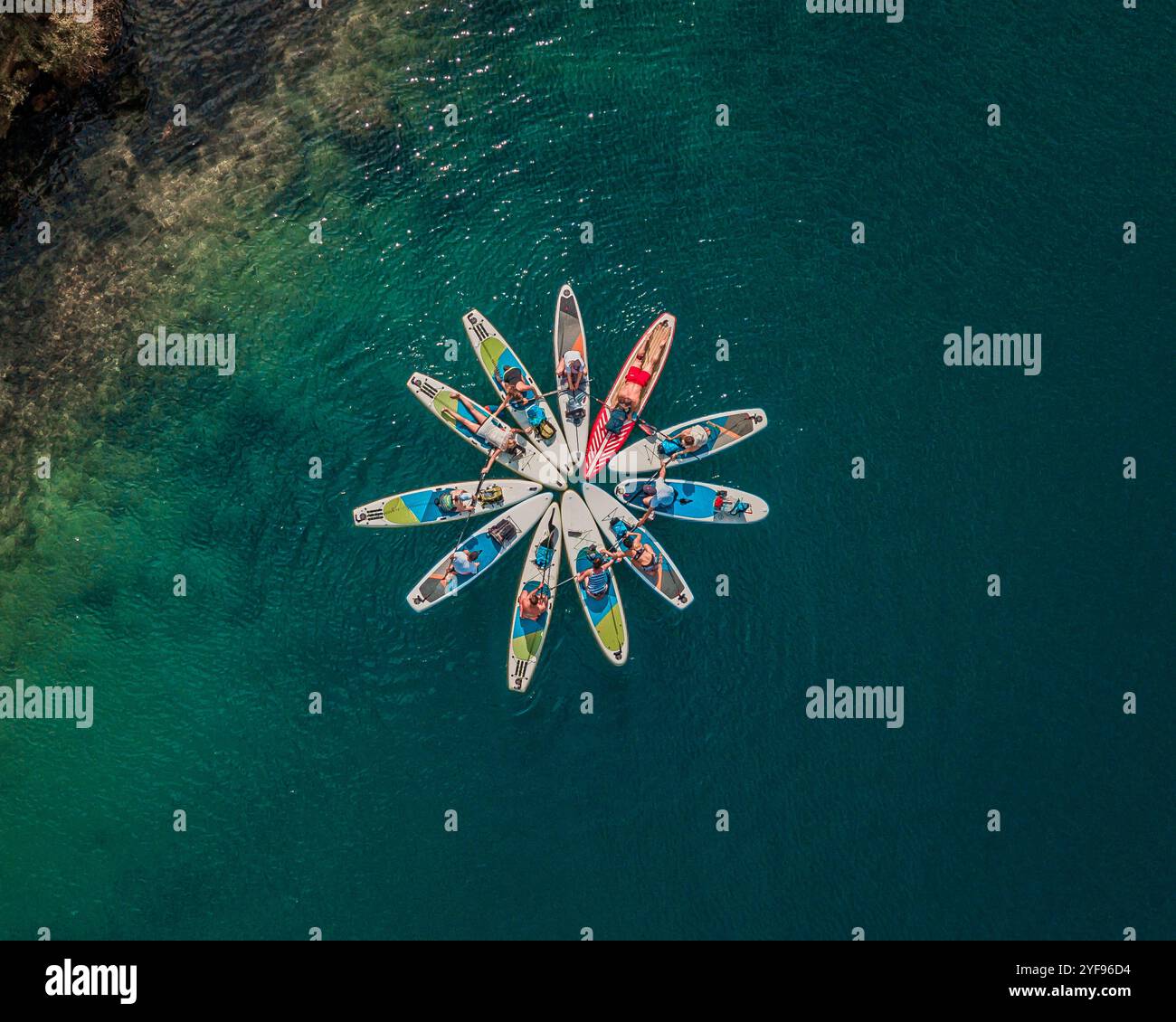 aerial view of a group of paddleboarders forming a star pattern on the ...