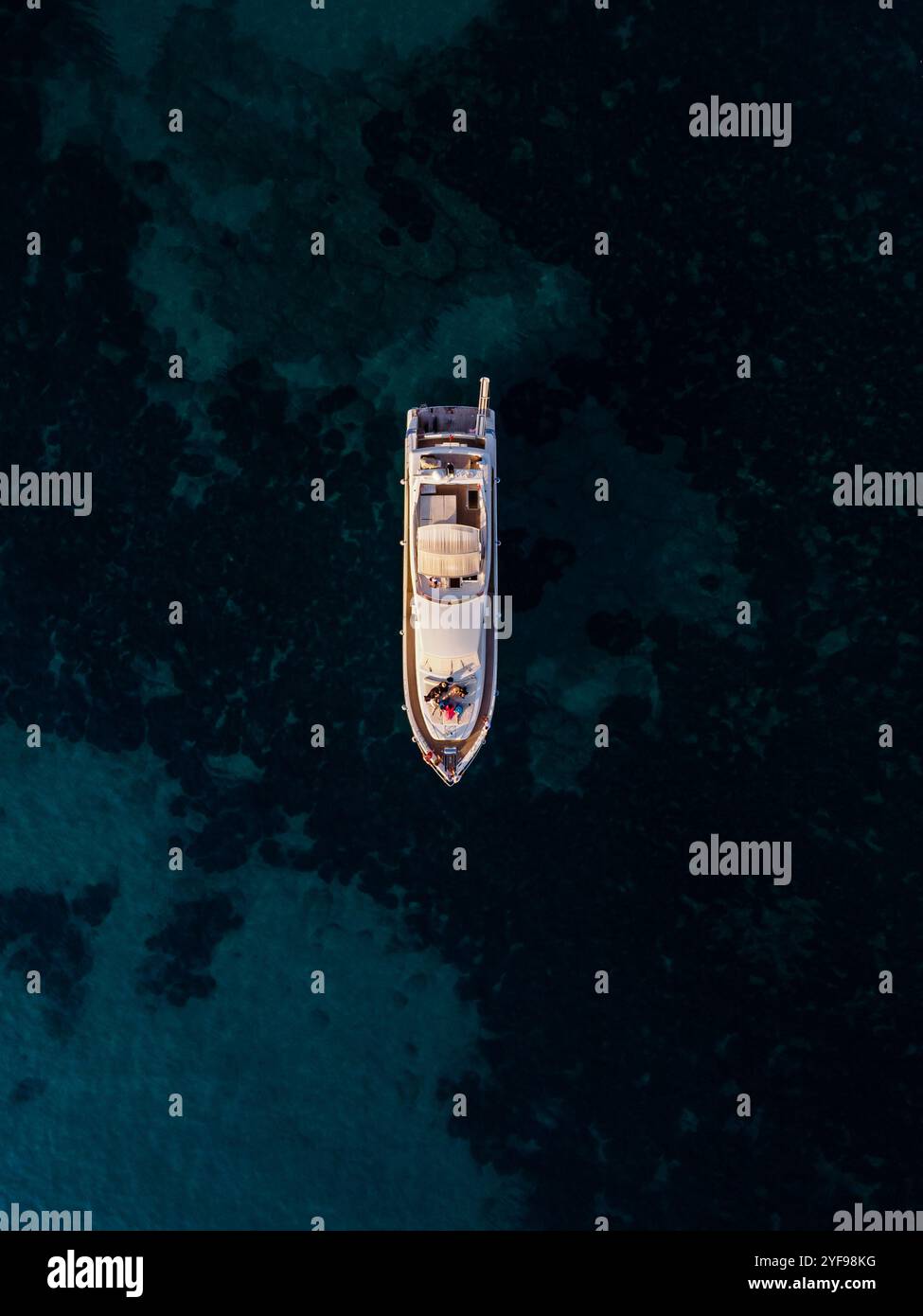 aerial drone view of a luxury yacht sailing on open water, showcasing ...