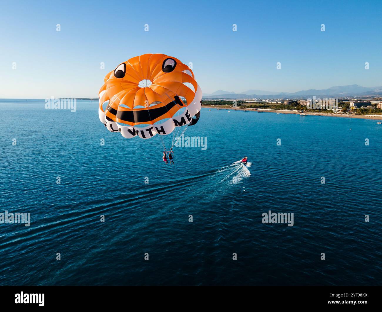 Parasailing in the clear blue sea at a luxury hotel resort, the ...