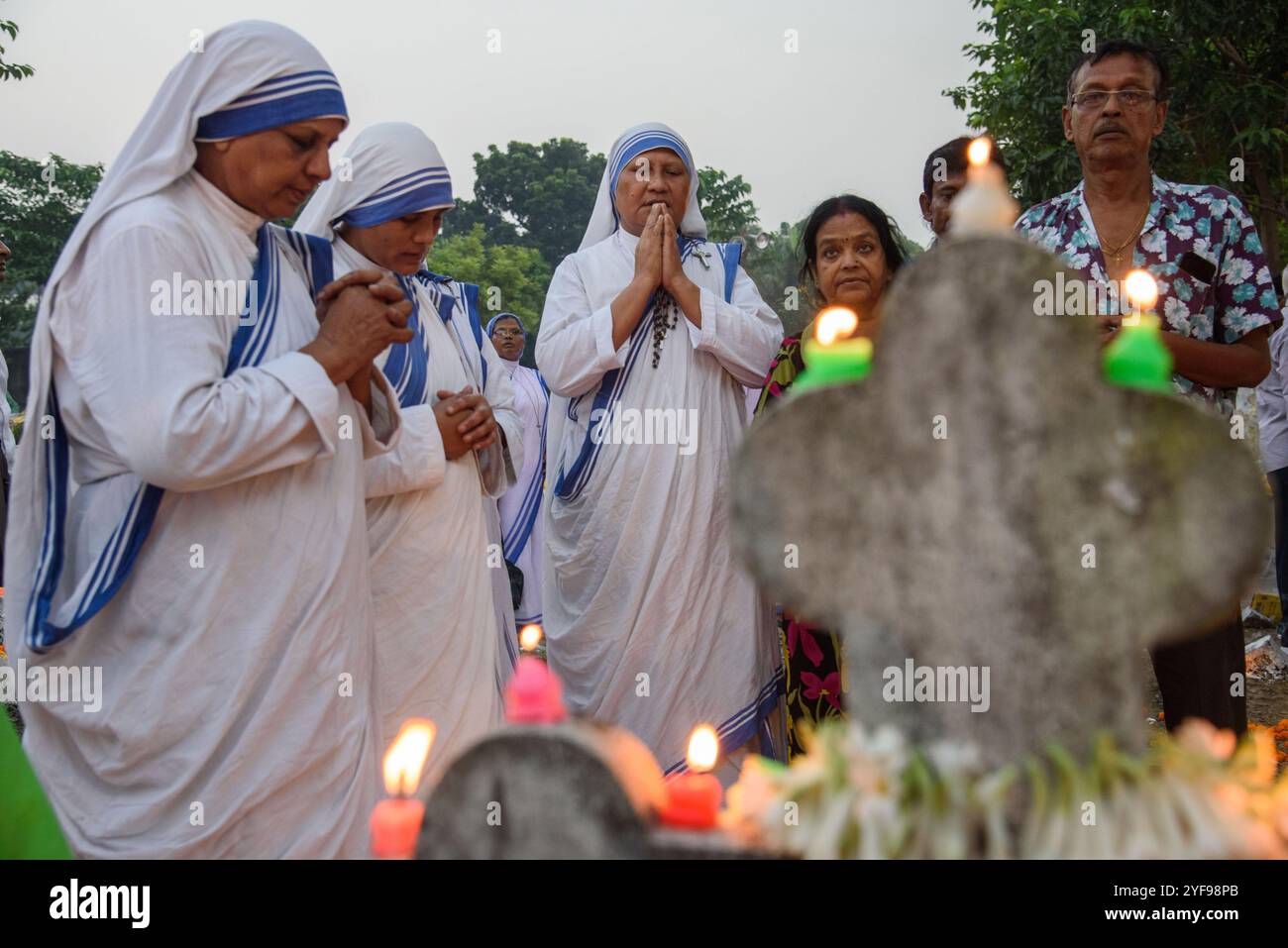 Non Exclusive: Nuns praying in front the graves during the All Souls ...