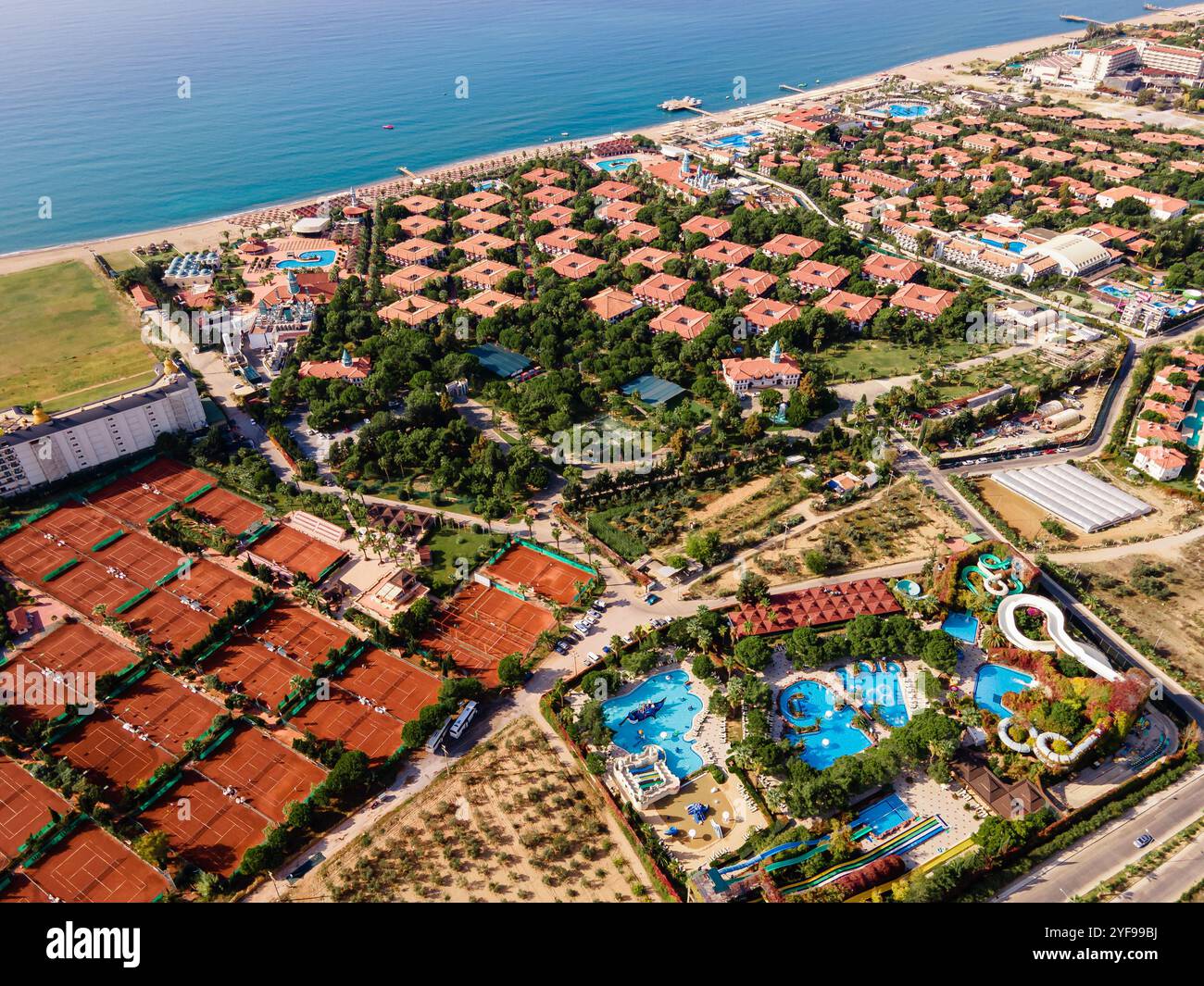 aerial view of multiple tennis courts, providing a glimpse of the ...