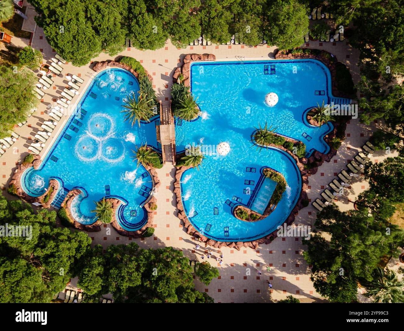 aerial view of an aqua park with large pools and slides in a luxurious ...