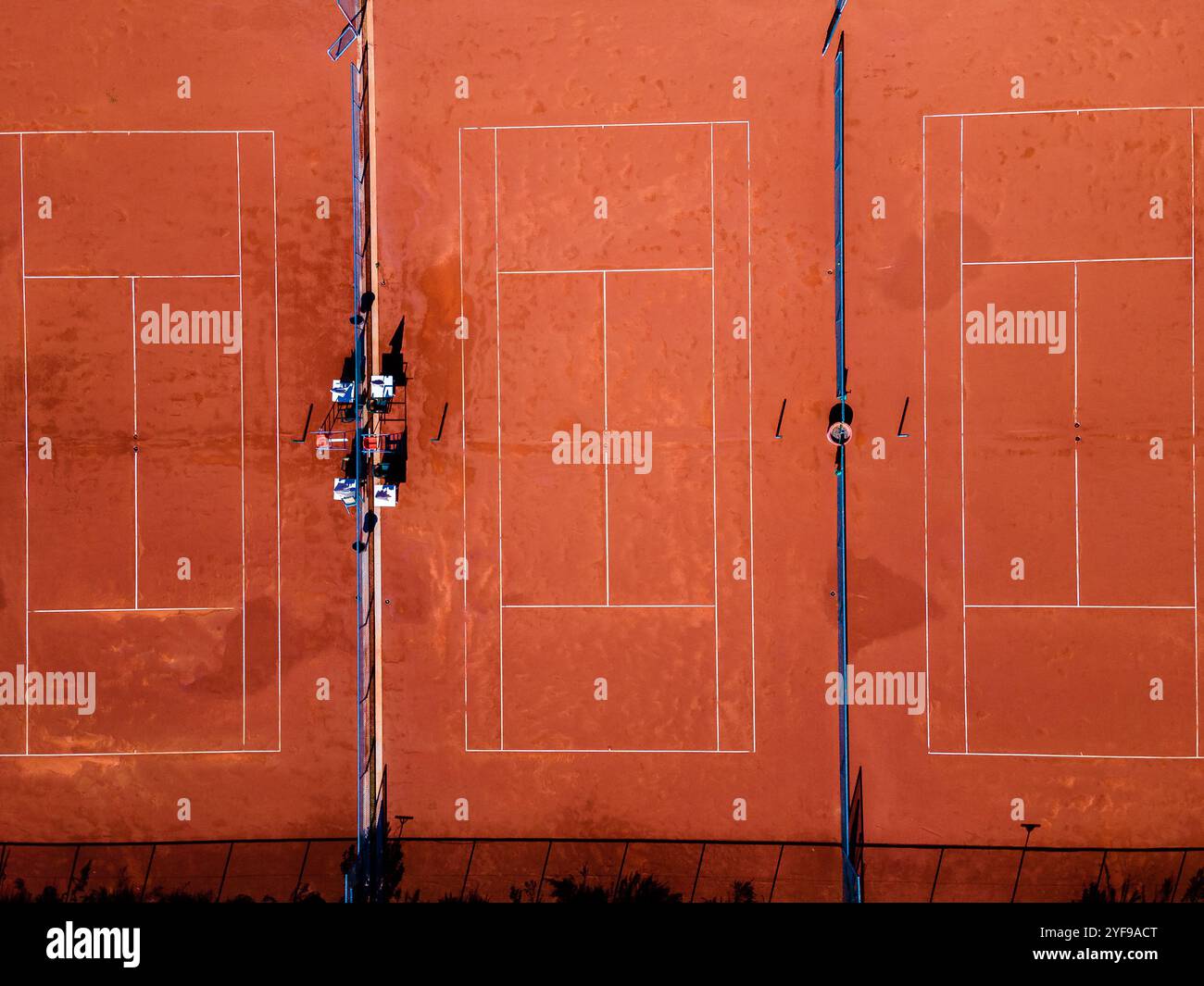 aerial view of multiple tennis courts, providing a glimpse of the ...