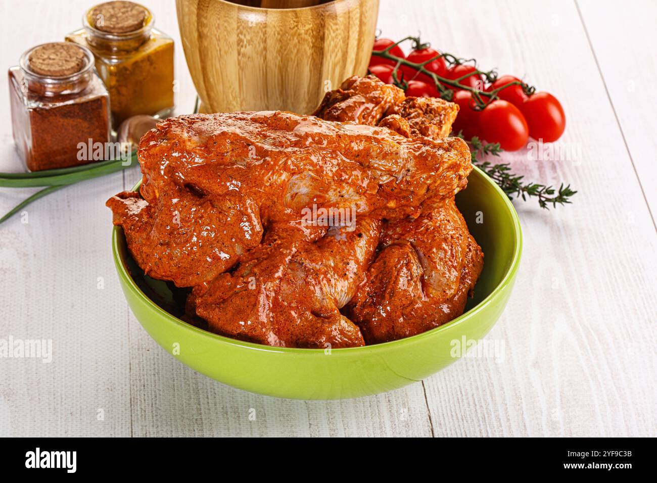 Raw turkey shoulder wing in Indian tandoori marinade spices Stock Photo ...