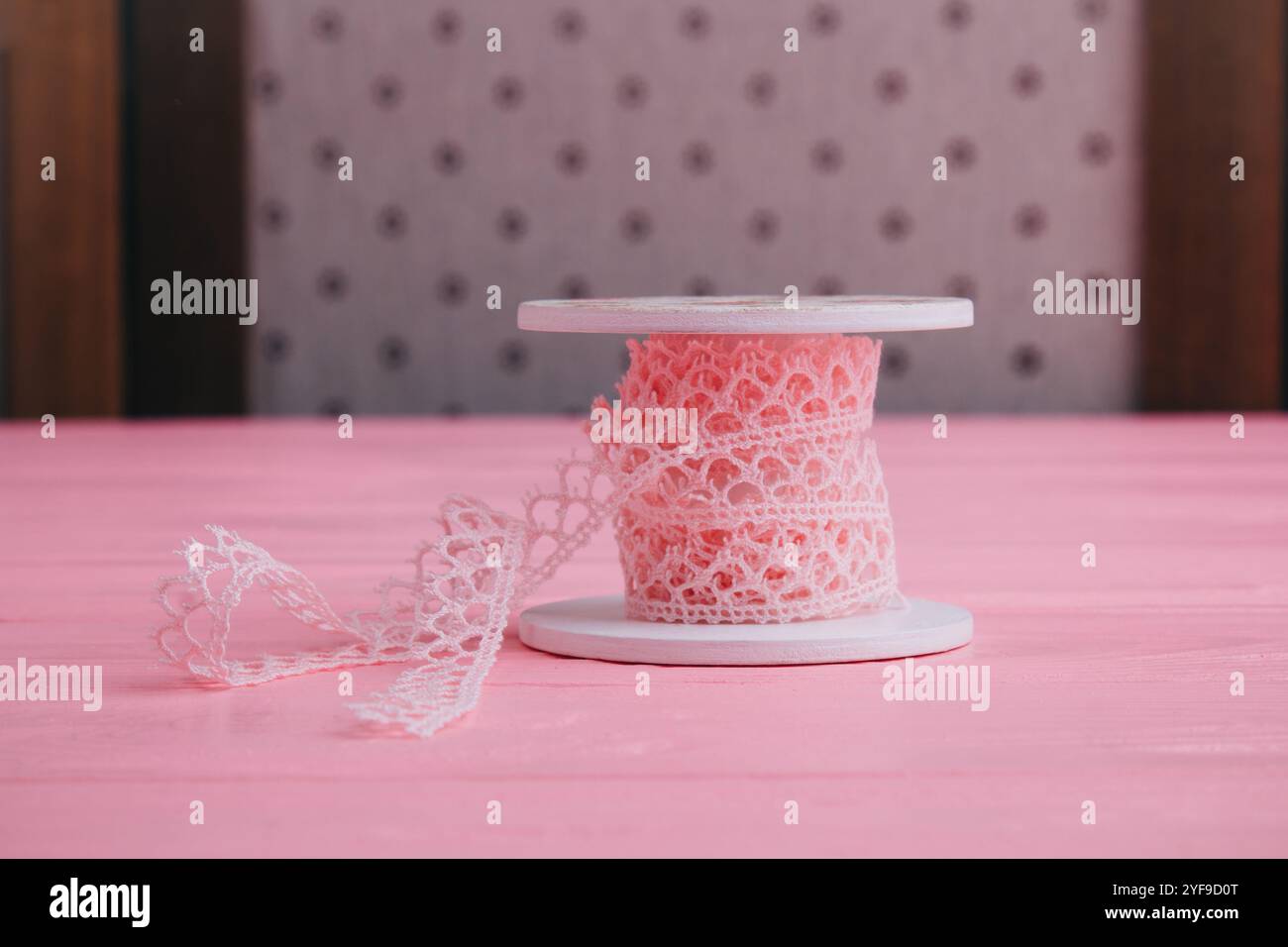 Floral spool holding a roll of pink lace ribbon, a perfect addition for ...