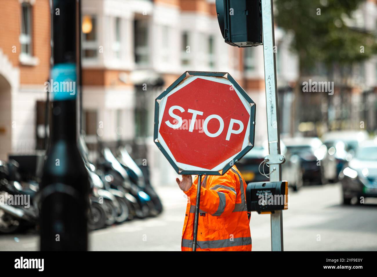 Road Construction Worker Holding a Stop Sign to Control Traffic Flow ...