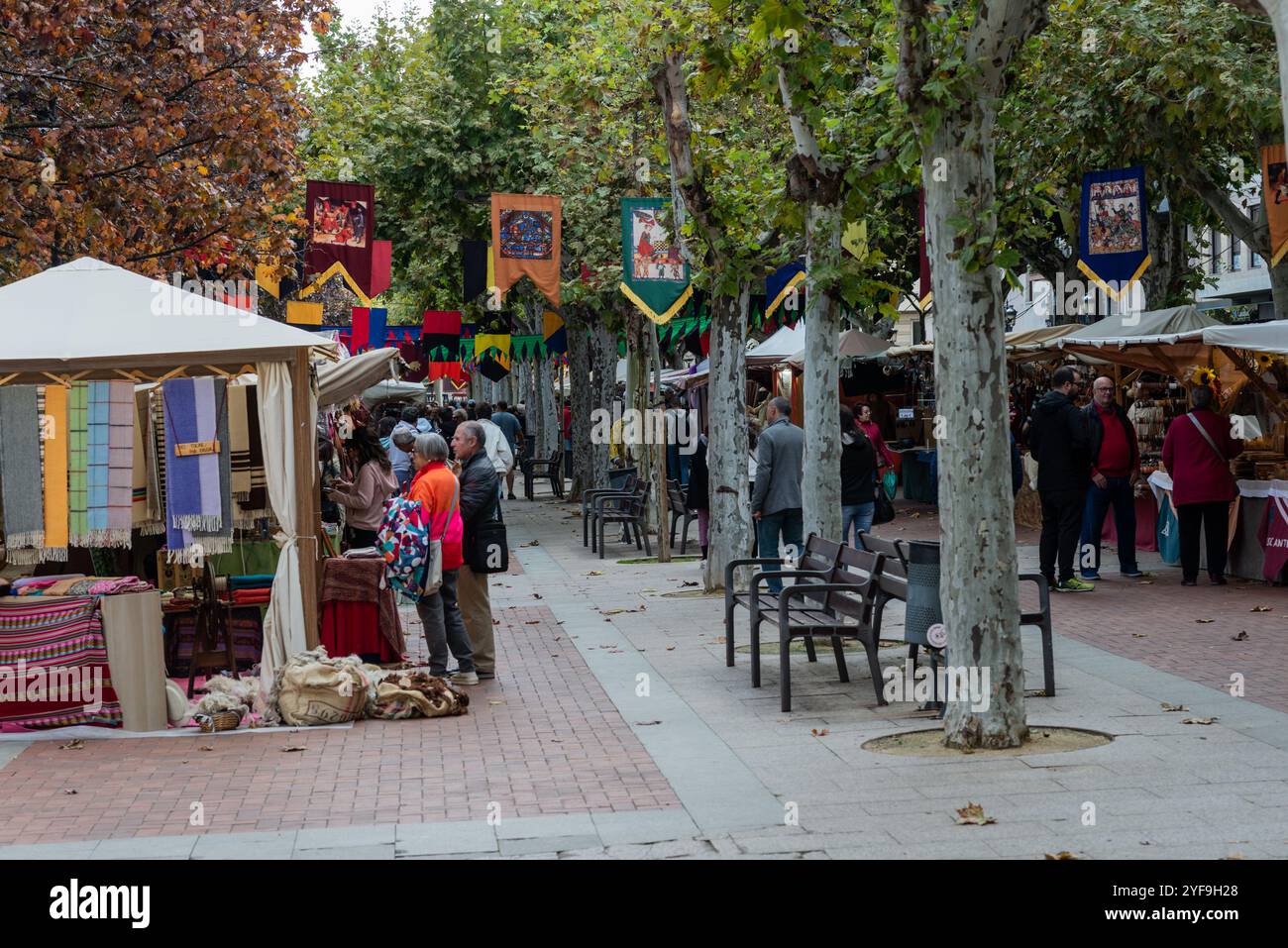 Street market with colorful medieval fair decorations in Barcelona ...