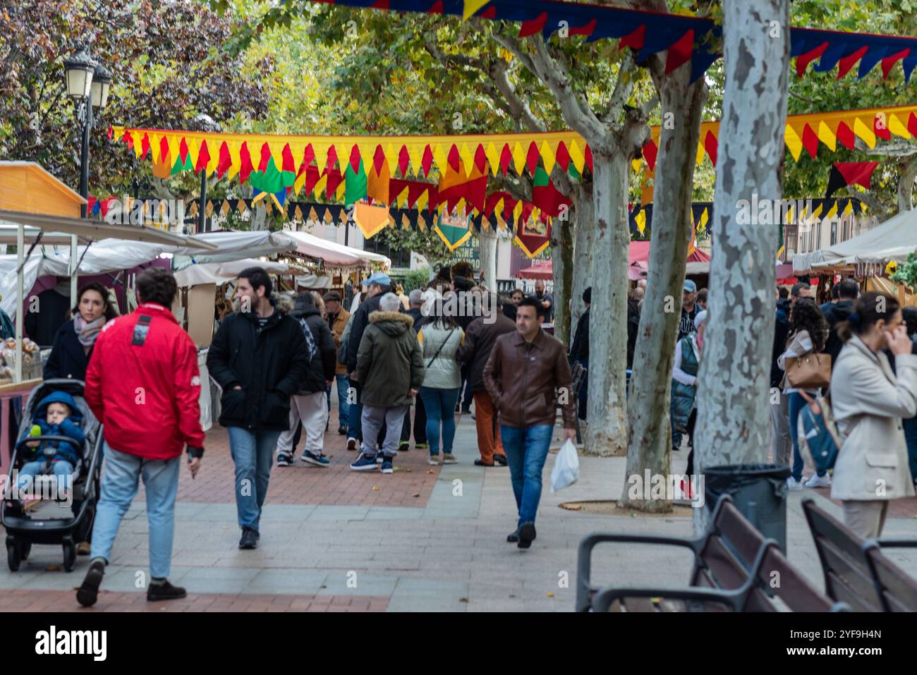 Street market with colorful medieval fair decorations in Barcelona ...