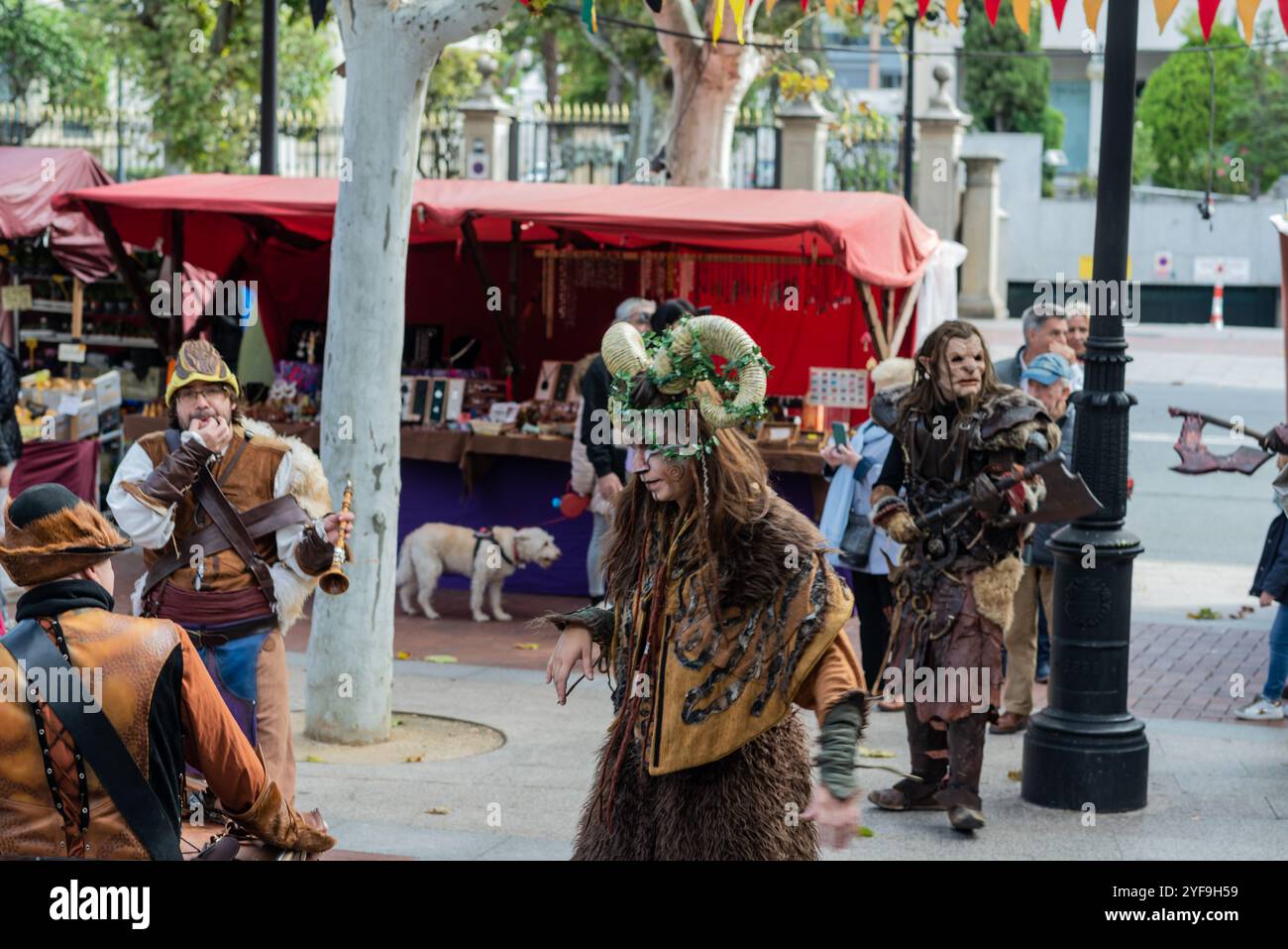 Street market with colorful medieval fair decorations in Barcelona ...