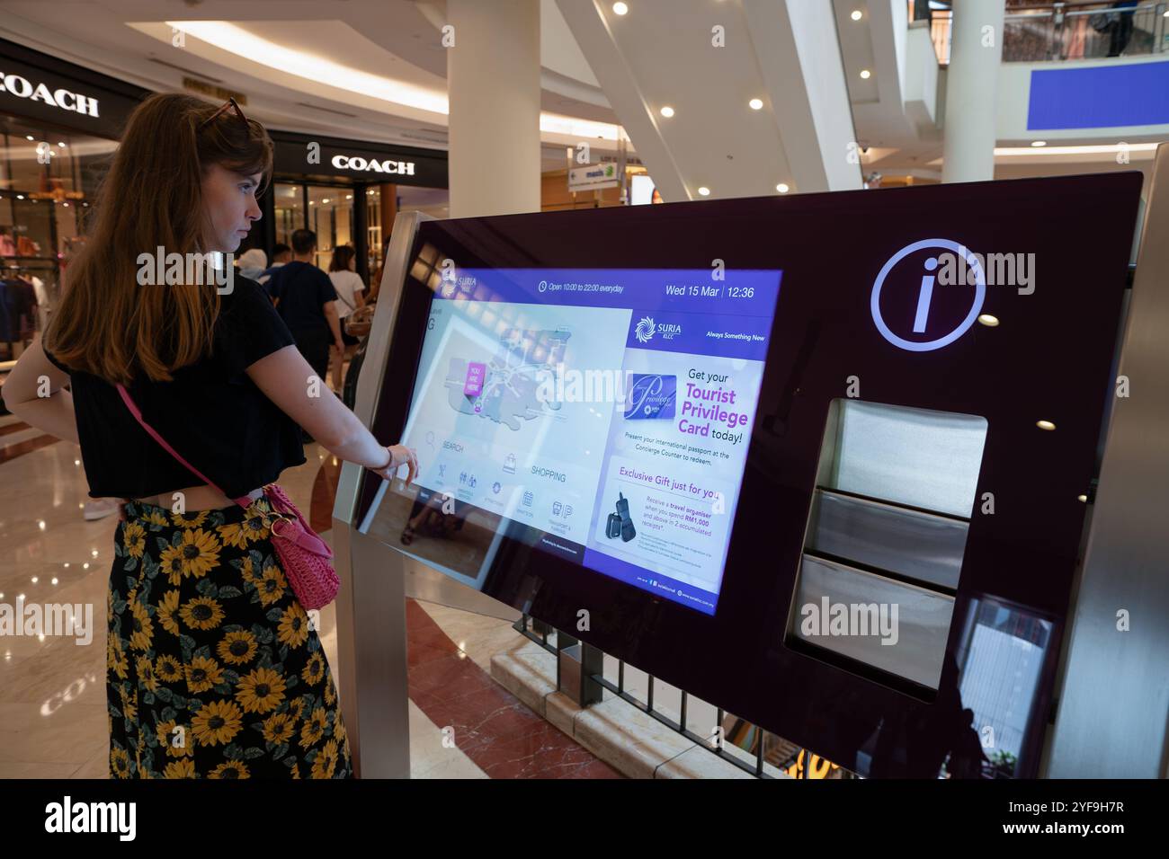 KUALA LUMPUR, MALAYSIA - MARCH 15, 2023: a woman use interactive information kiosk at Suria KLCC ...