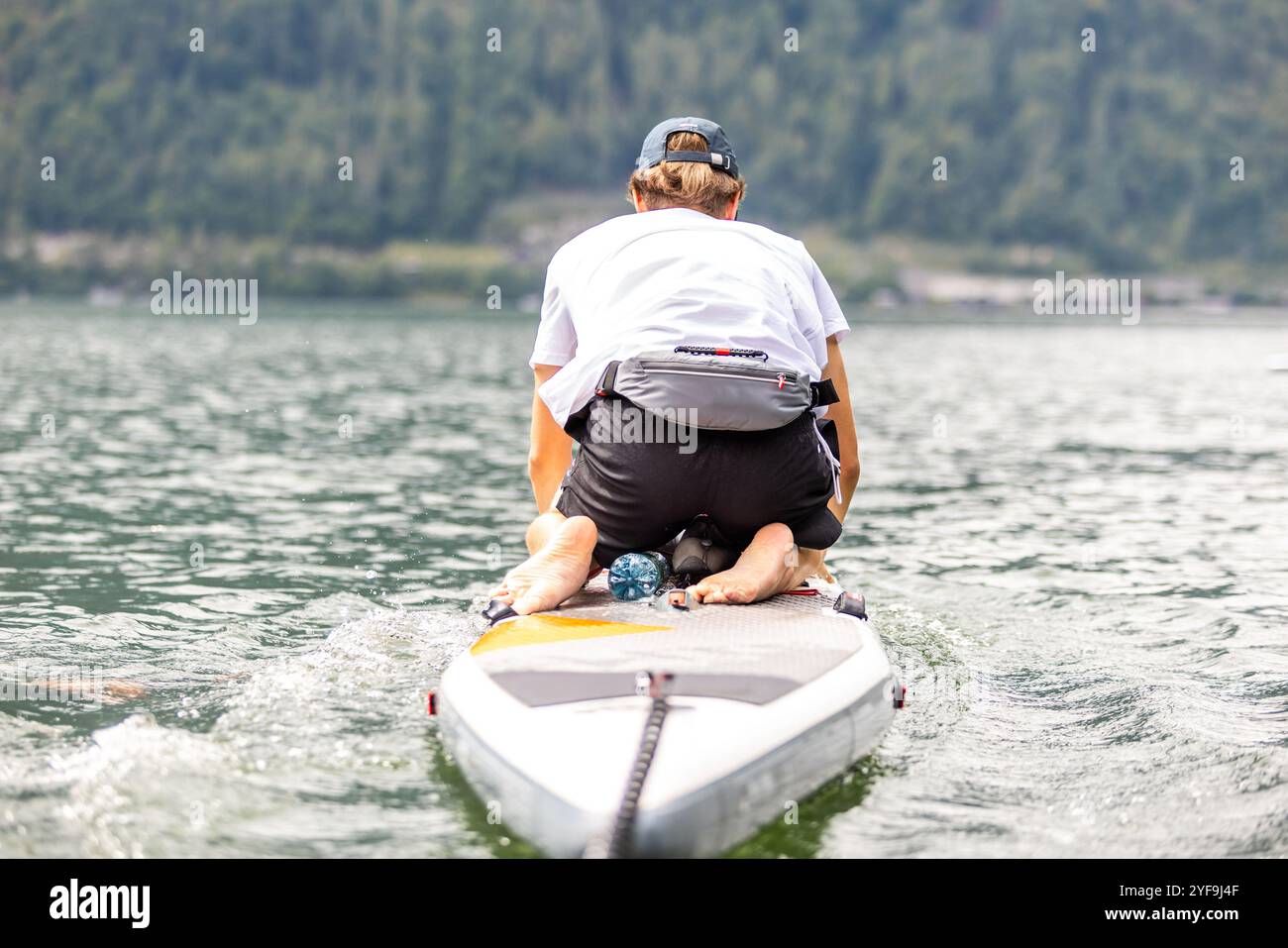 Back View of a Young Sporty Man on a SUP Board, Enjoying the Outdoors ...