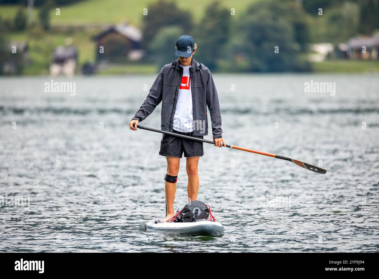 Young Sporty Man on Professional Inflatable SUP Board, Riding the Waves ...