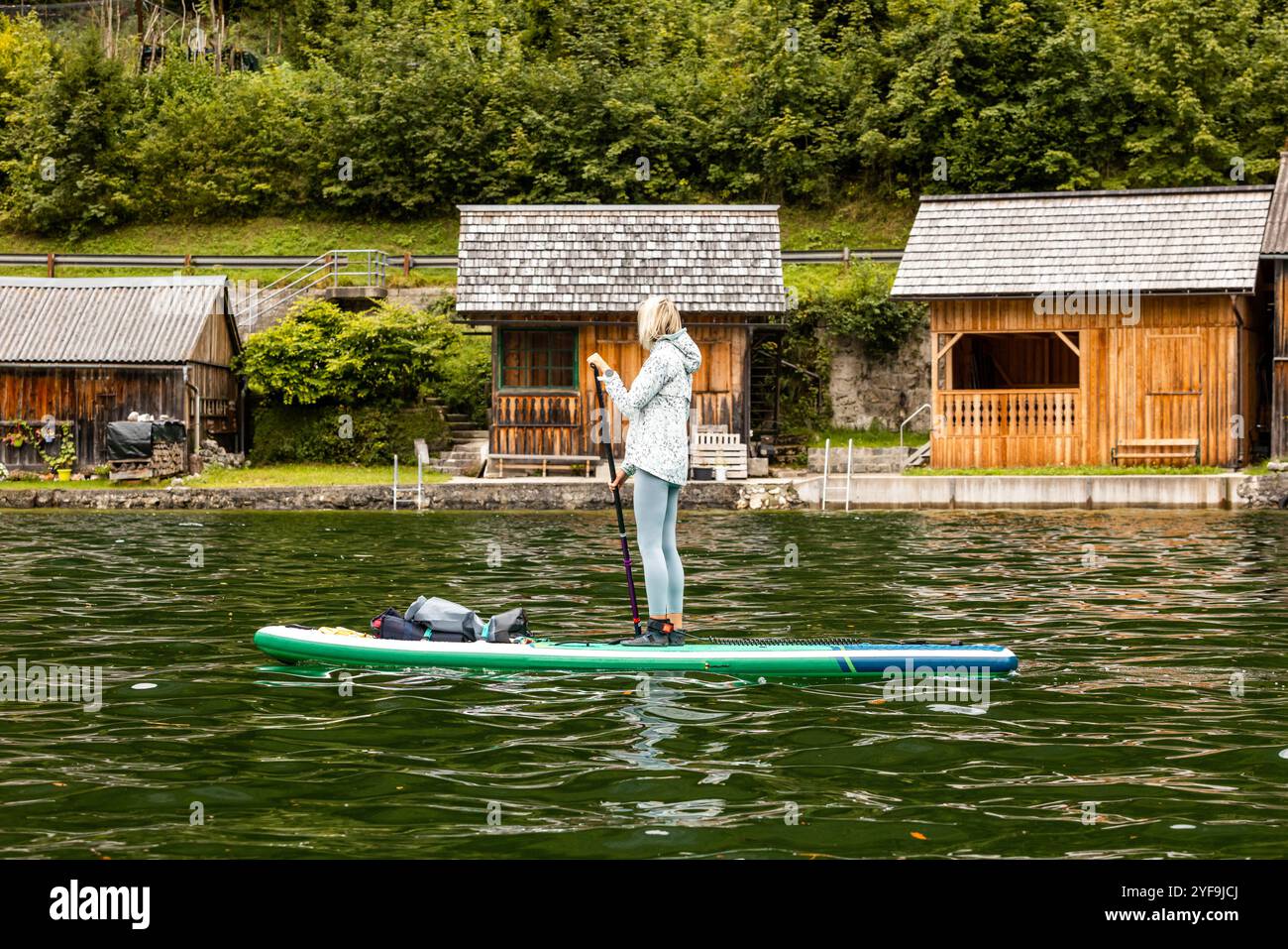 Back View of Woman in Sportswear Rowing with SUP Board on Calm Water ...