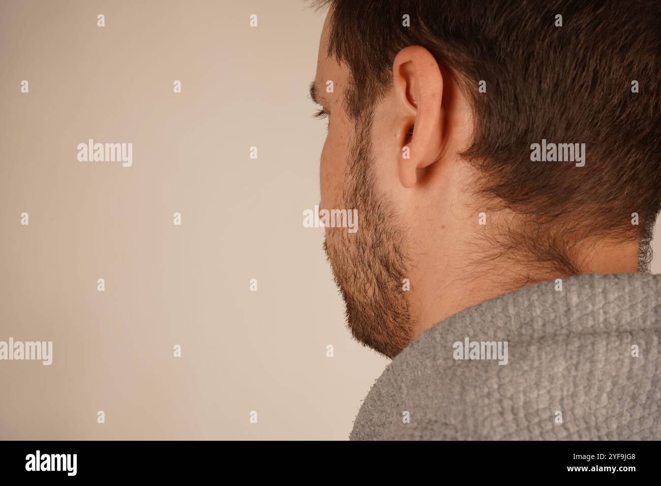 Neutral background. Male in casual clothes. Young guy standing in front ...