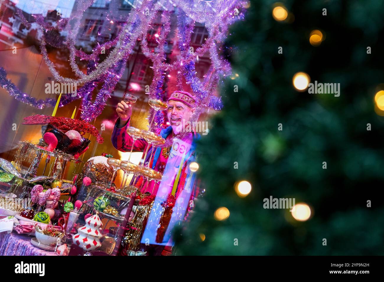 Artist Andrew Logan poses in his window during the unveiling of Selfridges Christmas windows on ...