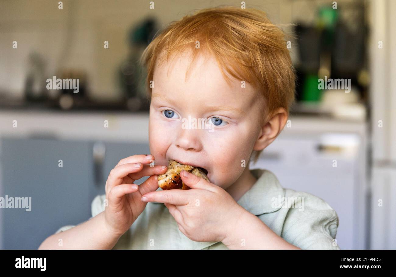 Close-up of cute boy eating breakfast at home Stock Photo - Alamy