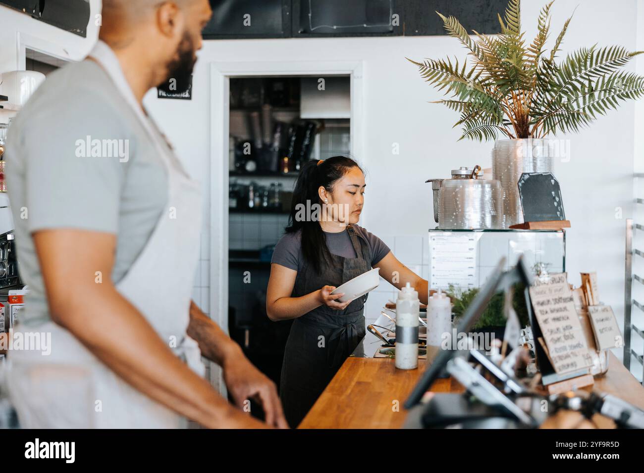 Two barista working in cafe Stock Photo - Alamy
