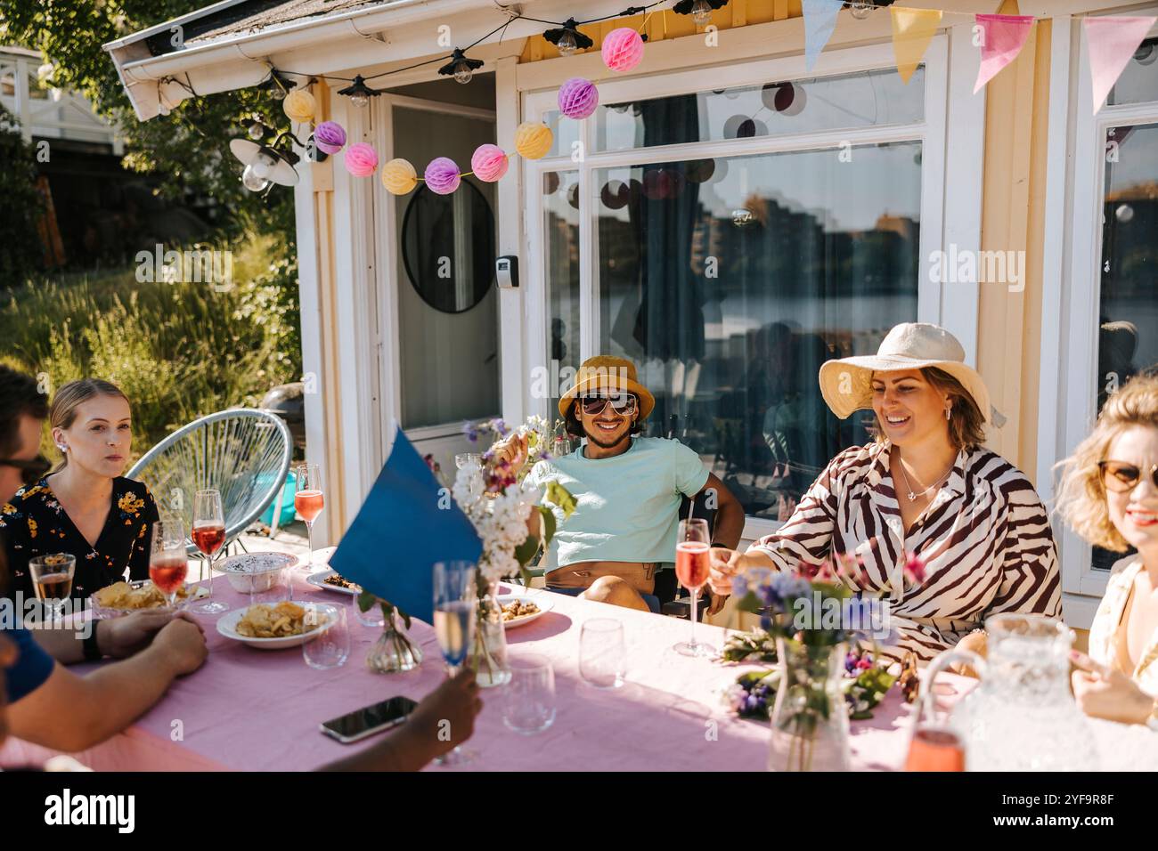 Group of friends enjoying party outside farmhouse Stock Photo - Alamy