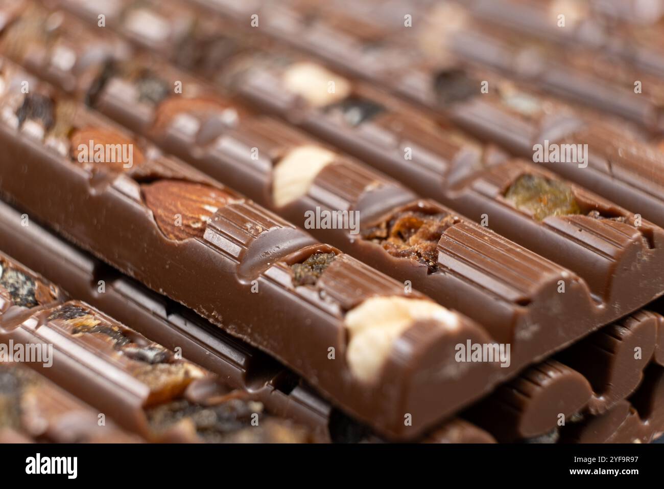 Macro background of milk nut chocolate with raisins Stock Photo - Alamy