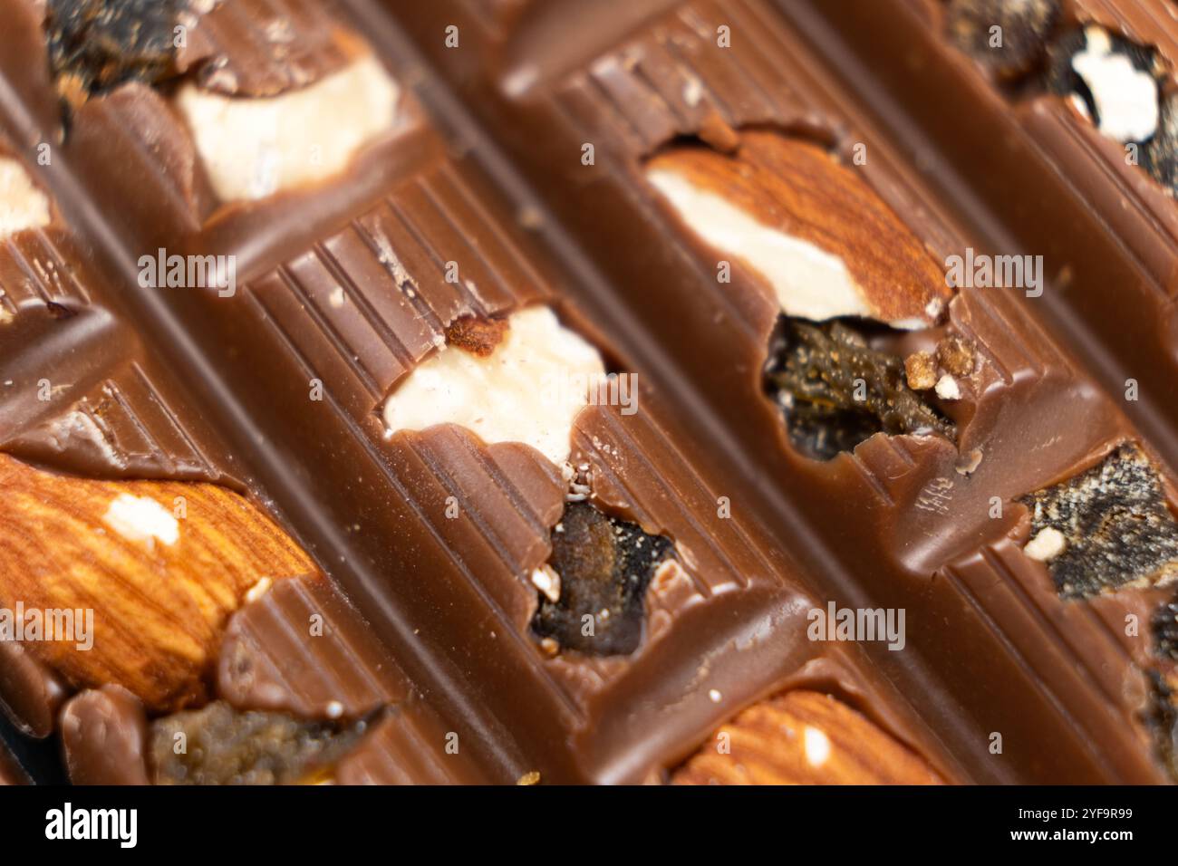 Macro background of milk nut chocolate with raisins Stock Photo - Alamy