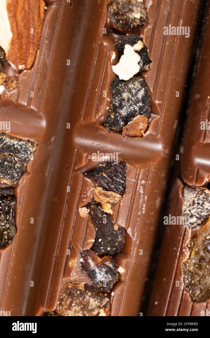 Macro background of milk nut chocolate with raisins Stock Photo - Alamy