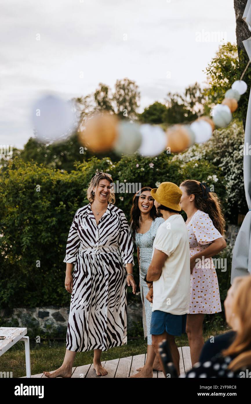 Group of friends enjoying party at lakeside Stock Photo - Alamy