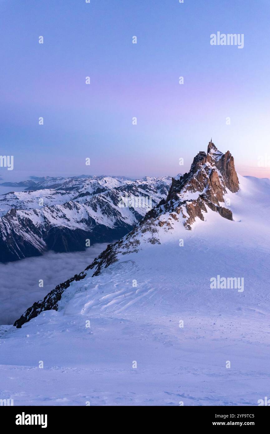 Aiguille du Midi and Cosmiques Ridge during purple sunrise in Chamonix ...