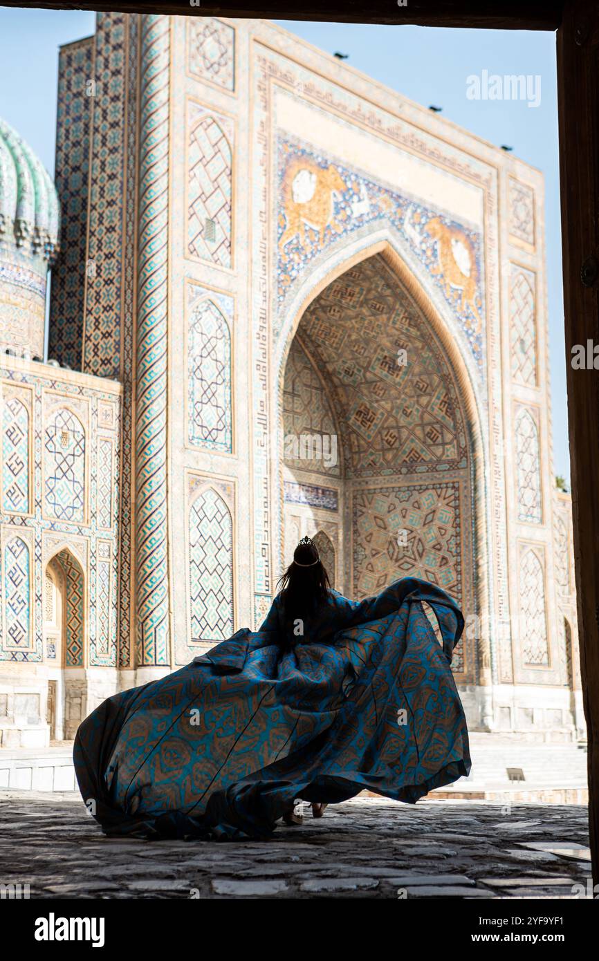Young woman in traditional Uzbek dress at Ulug bek madrassah, Registan ...