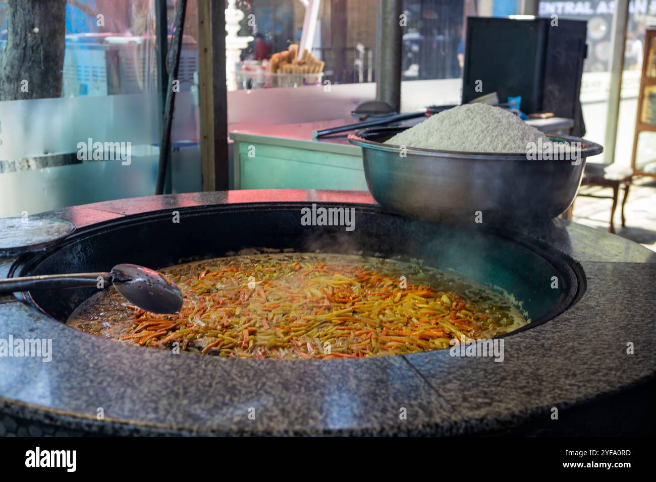 Real Uzbek pilaf in a huge cauldron. Center for pilaf in Tashkent ...