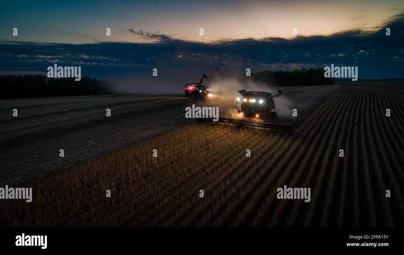 Combine harvester dusk harvesting hi-res stock photography and images ...