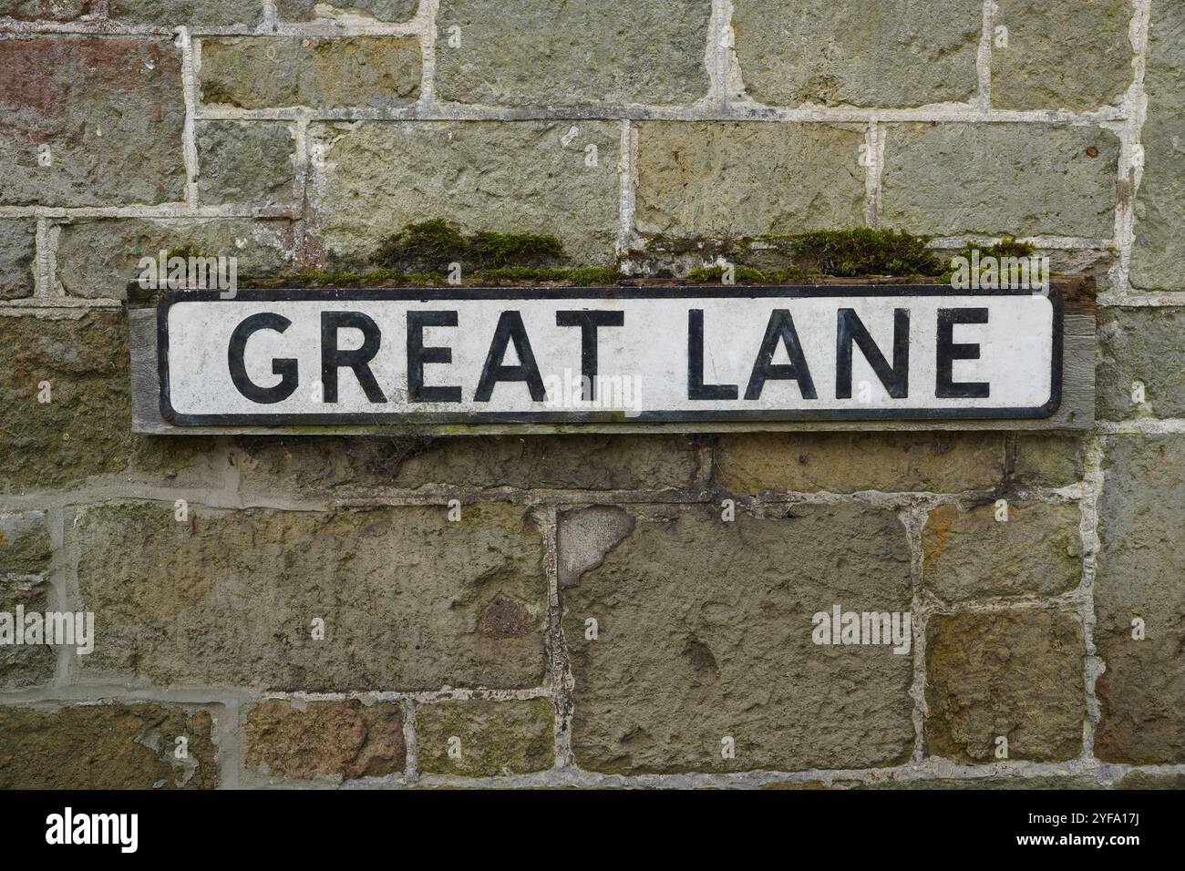 Road sign against a stone wall hi-res stock photography and images - Alamy