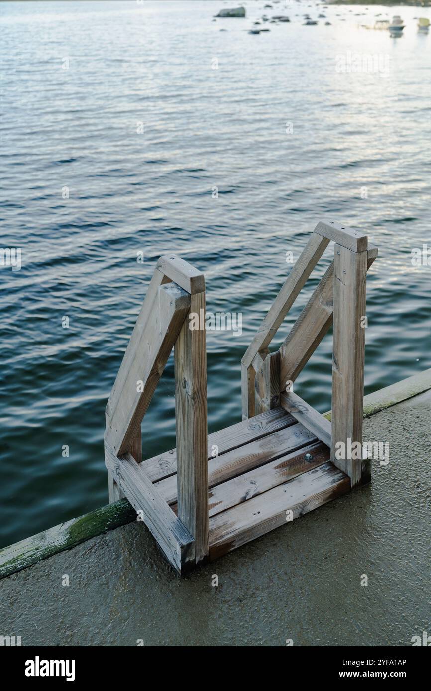 Sideview of a ladder into the blue sea Stock Photo - Alamy