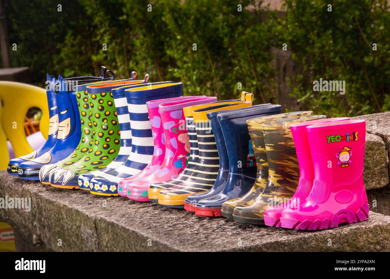 Children's colourful wellington boots lined up Stock Photo - Alamy