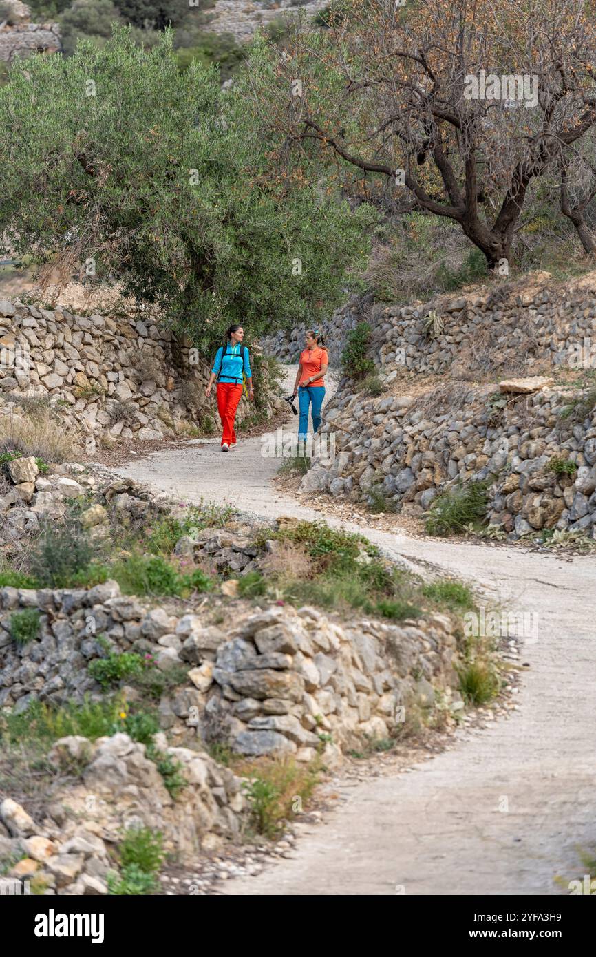Female hikers exploring lush greenery and rugged terrain Stock Photo ...