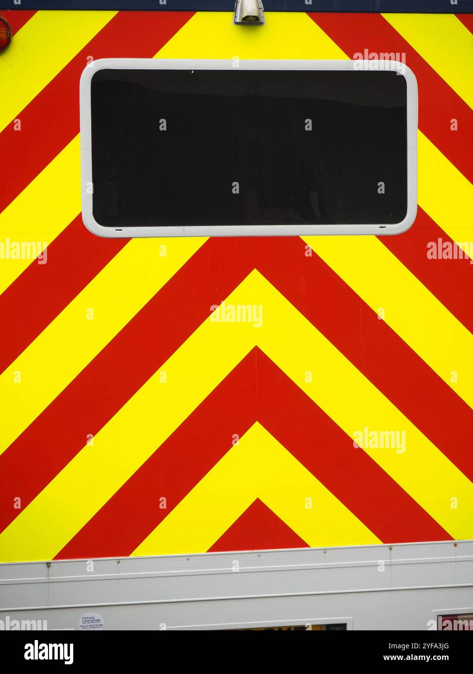 Red and yellow chevron pattern danger or warning stripes on rear of ...