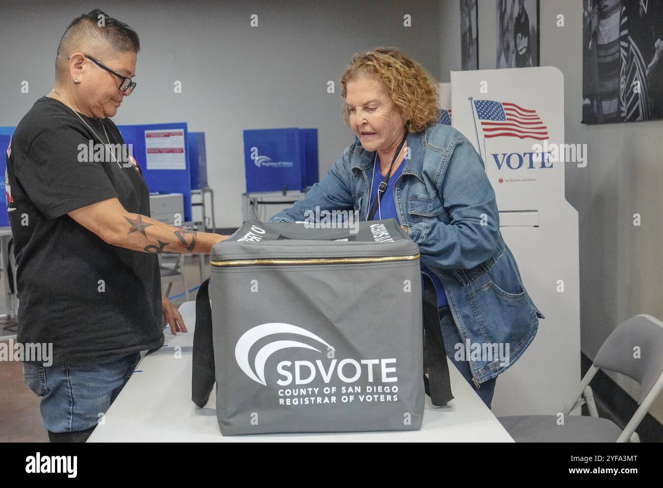 The voters put the ballots into the official ballot box at the vote ...