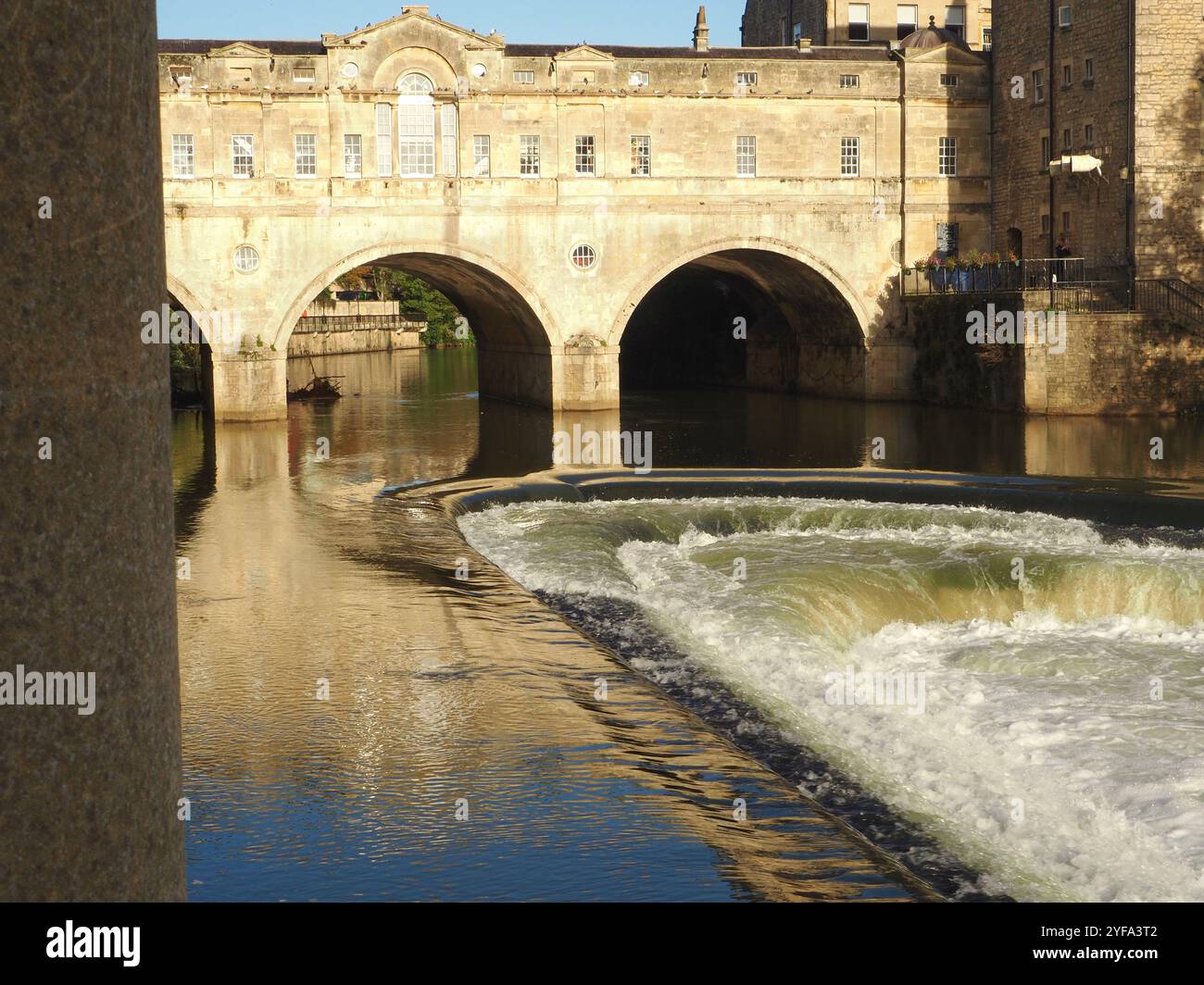 Pulteney weir, in spate after heavy rain, with Pulteney Bridge in ...