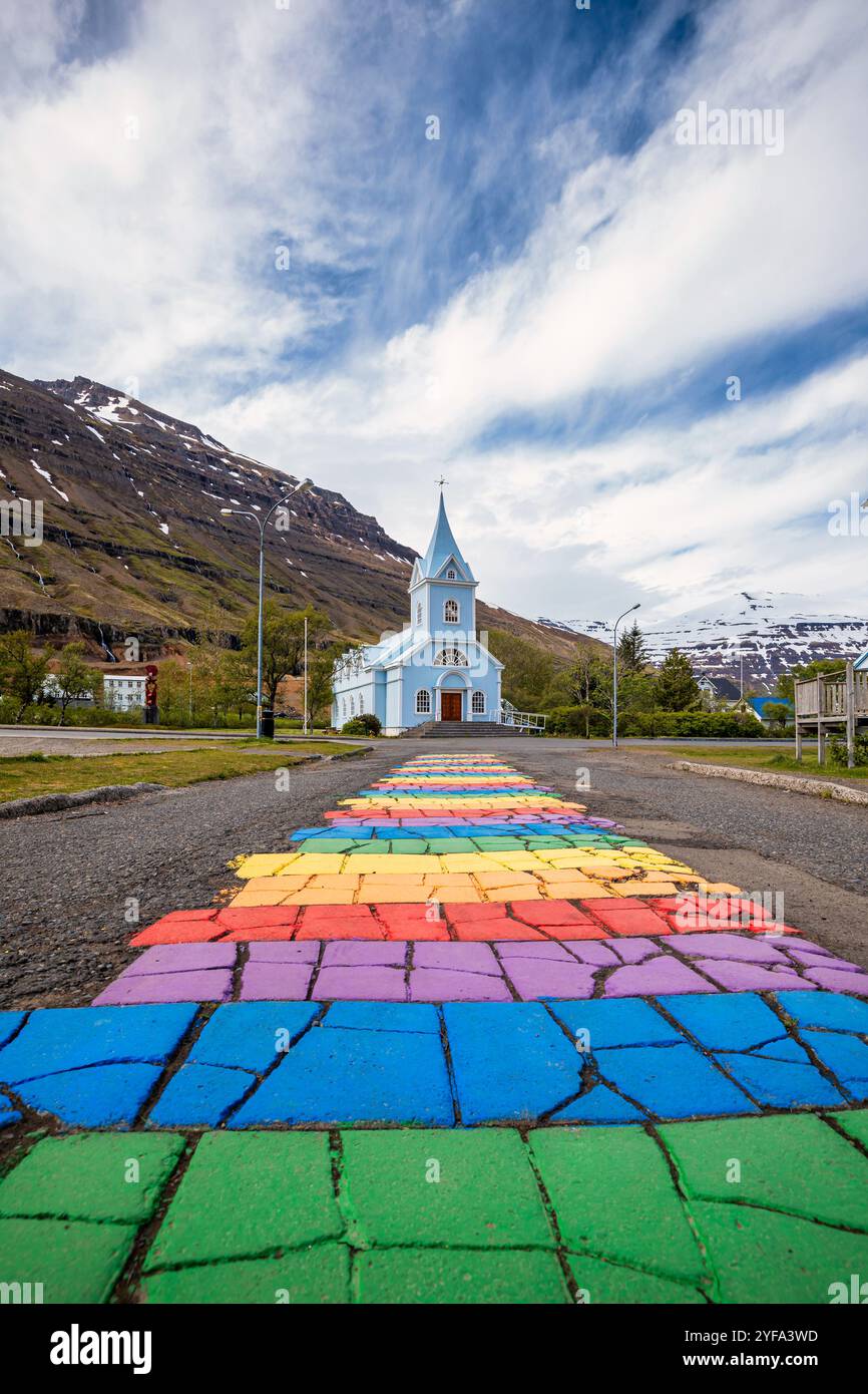 The famous rainbow road in Seydisfjordur with icelandic buildings ...