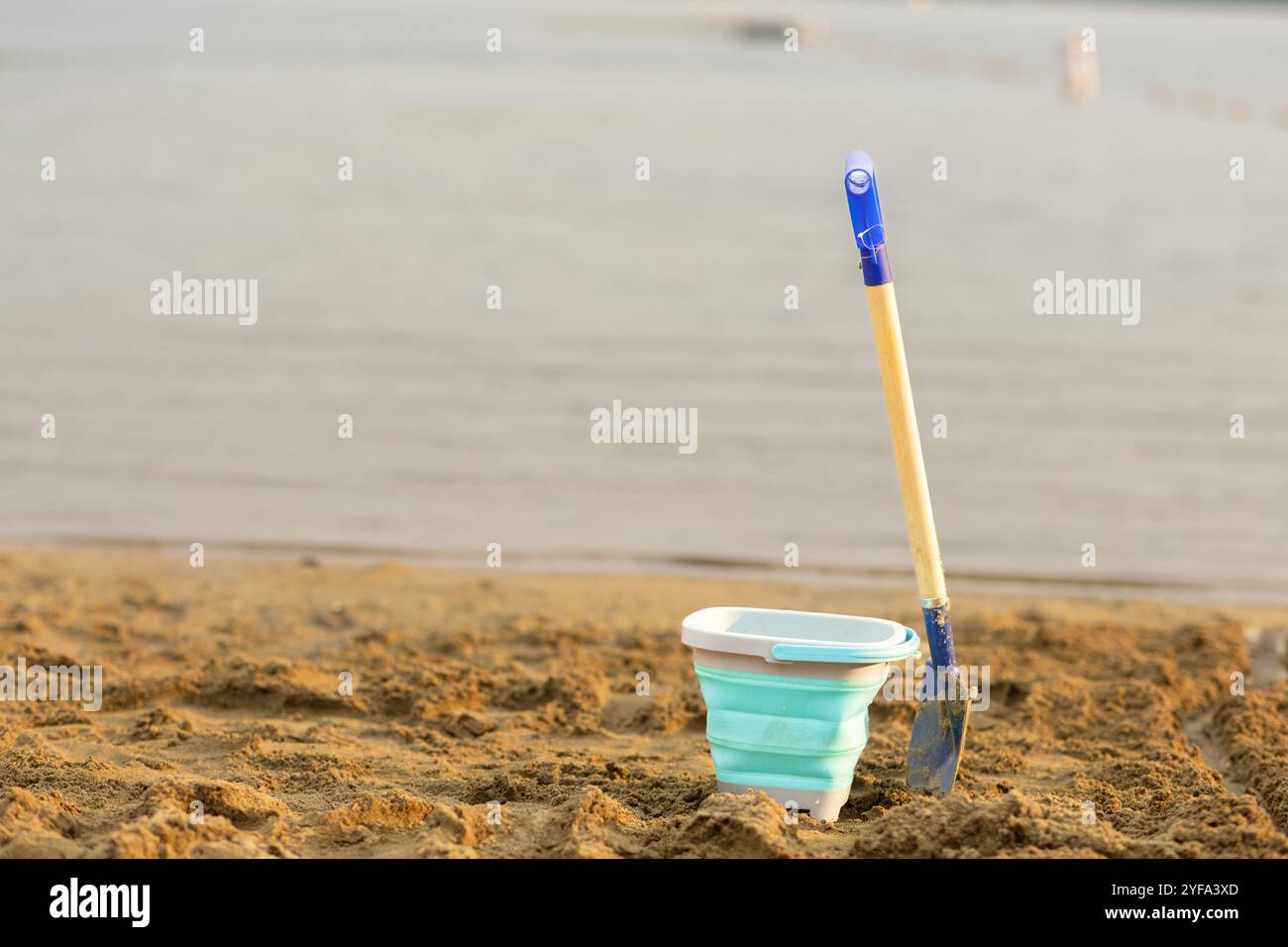 Family on beach with sand pail hi-res stock photography and images - Alamy