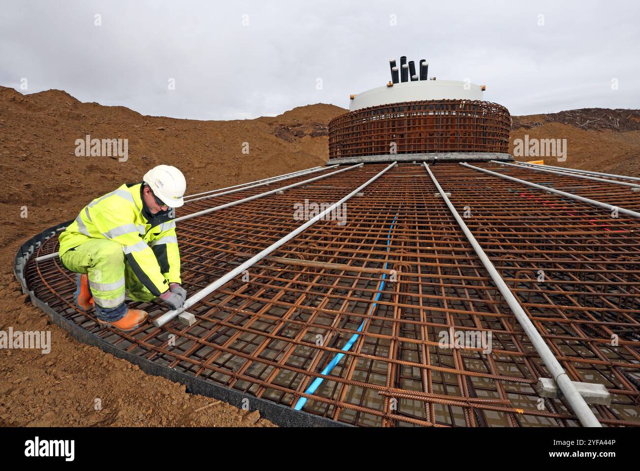 Wind turbine foundation with workers during windfarm infrastructure ...