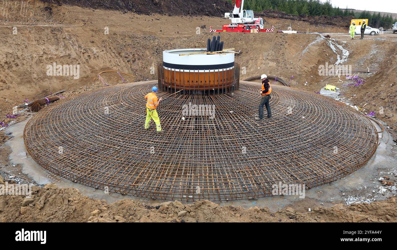 Wind turbine foundation with workers during windfarm infrastructure ...