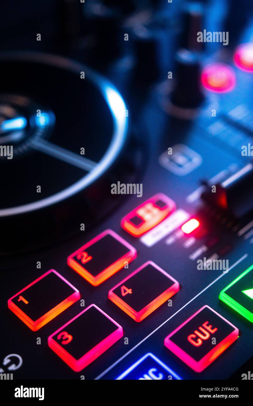DJ mixing desk turntable in colored wedding disco party lights Stock ...