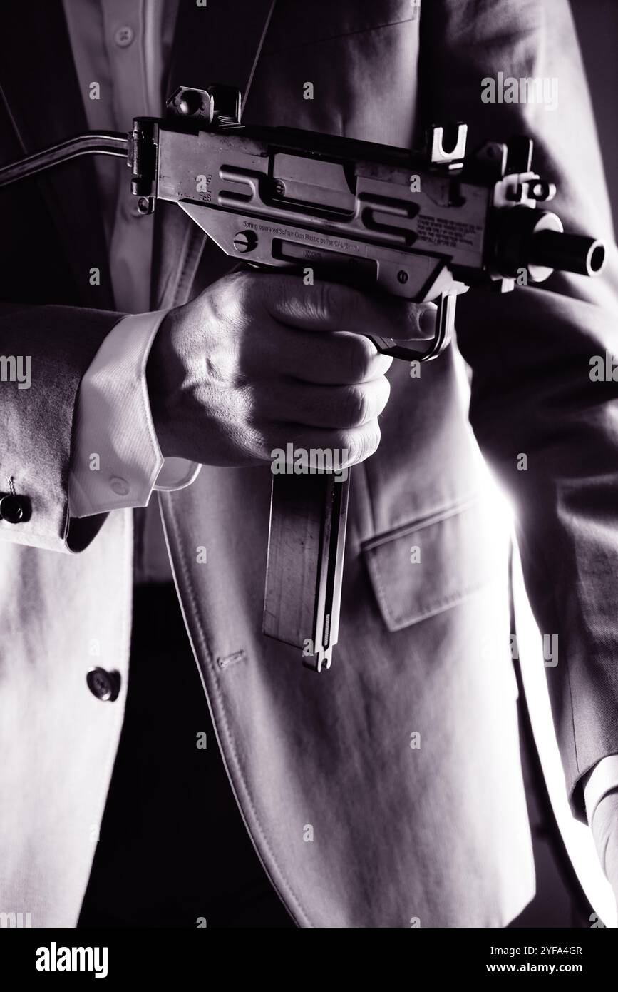 Retro secret agent with porstol revolver gun in hand in vintage crime ...
