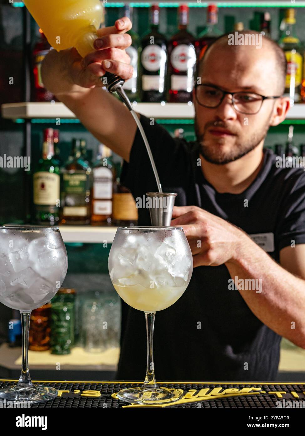 Happy bartender pouring liqueur hi-res stock photography and images - Alamy