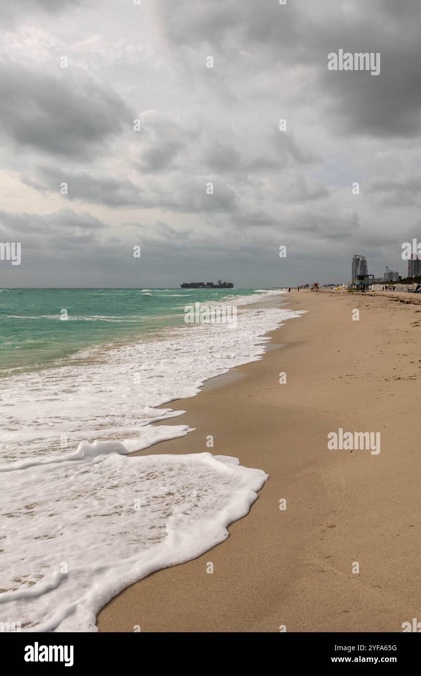 Foamy waves washing beach under hi-res stock photography and images - Alamy
